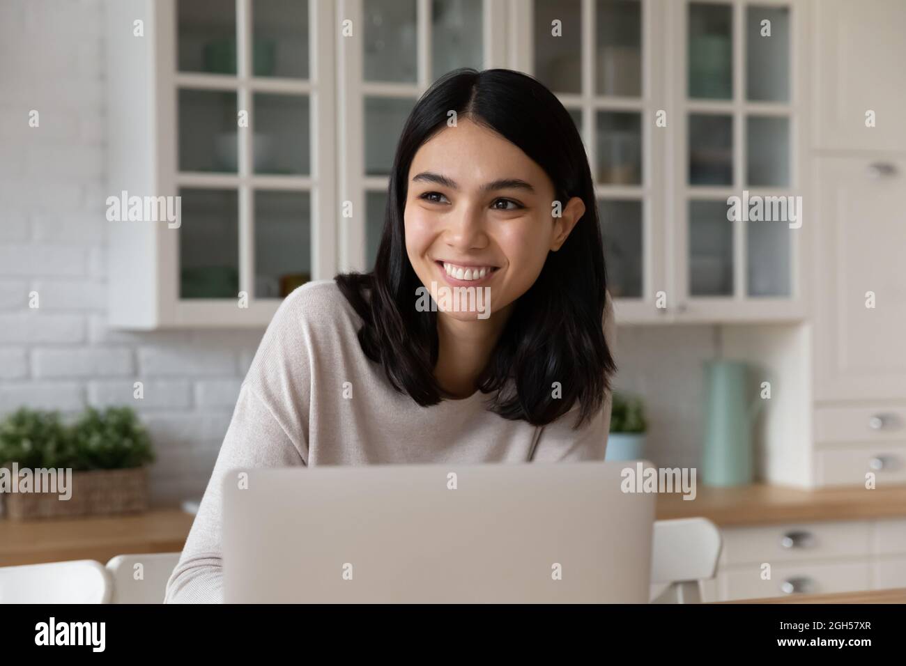 Dreamy happy millennial asian woman creatin new project Stock Photo - Alamy