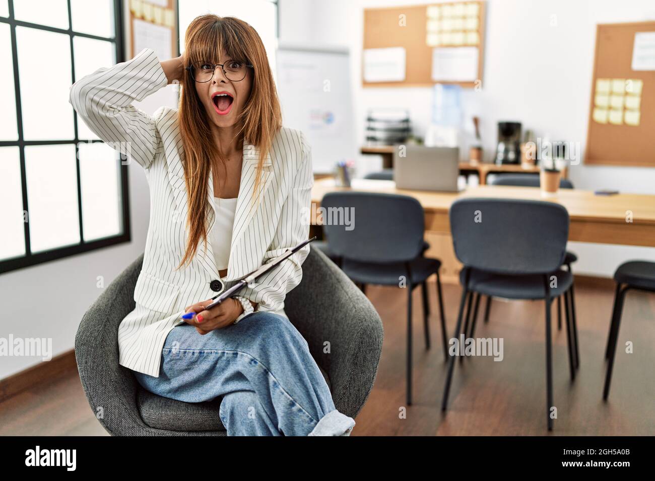 Hispanic business woman working at the office crazy and scared with ...