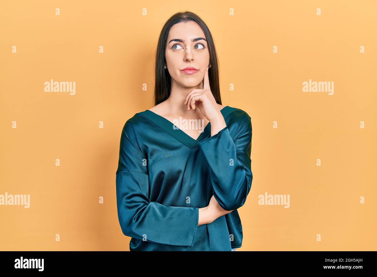 Beautiful woman with blue eyes wearing elegant shirt serious face ...