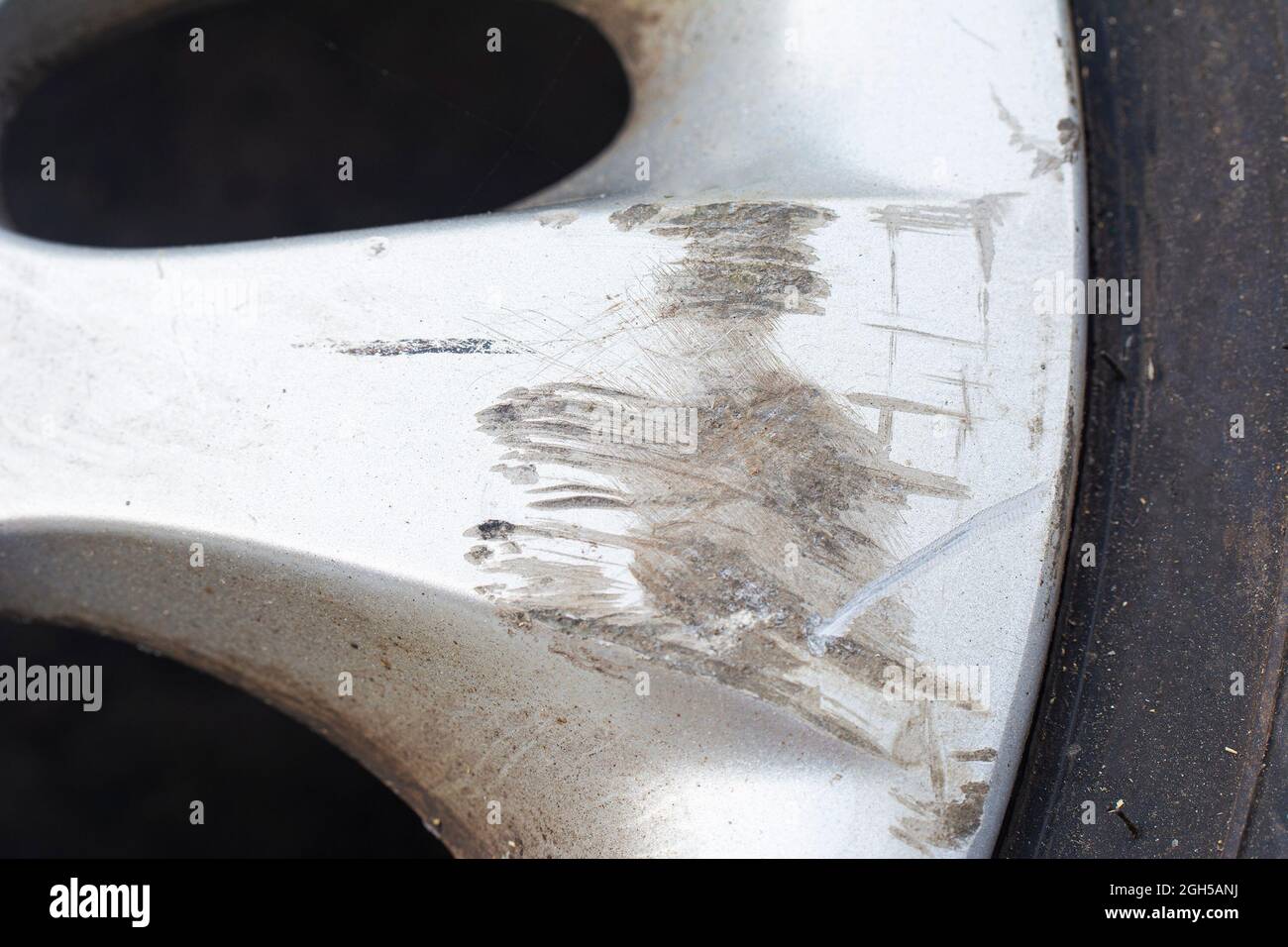 Damaged car wheel disk. Scratch and dirty aluminium wheel rim ...