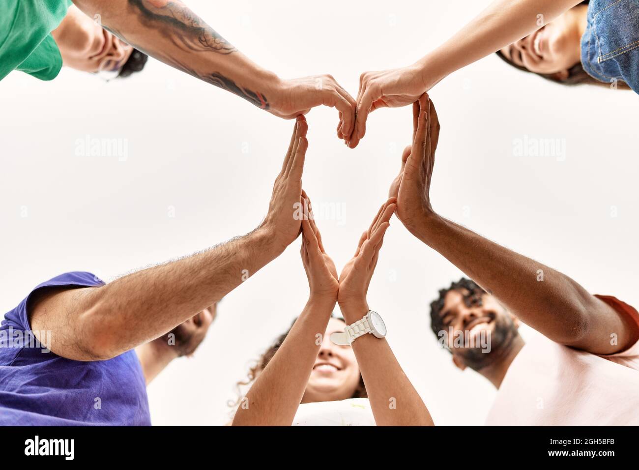 Group of young friends with hands together doing heart symbol Stock ...