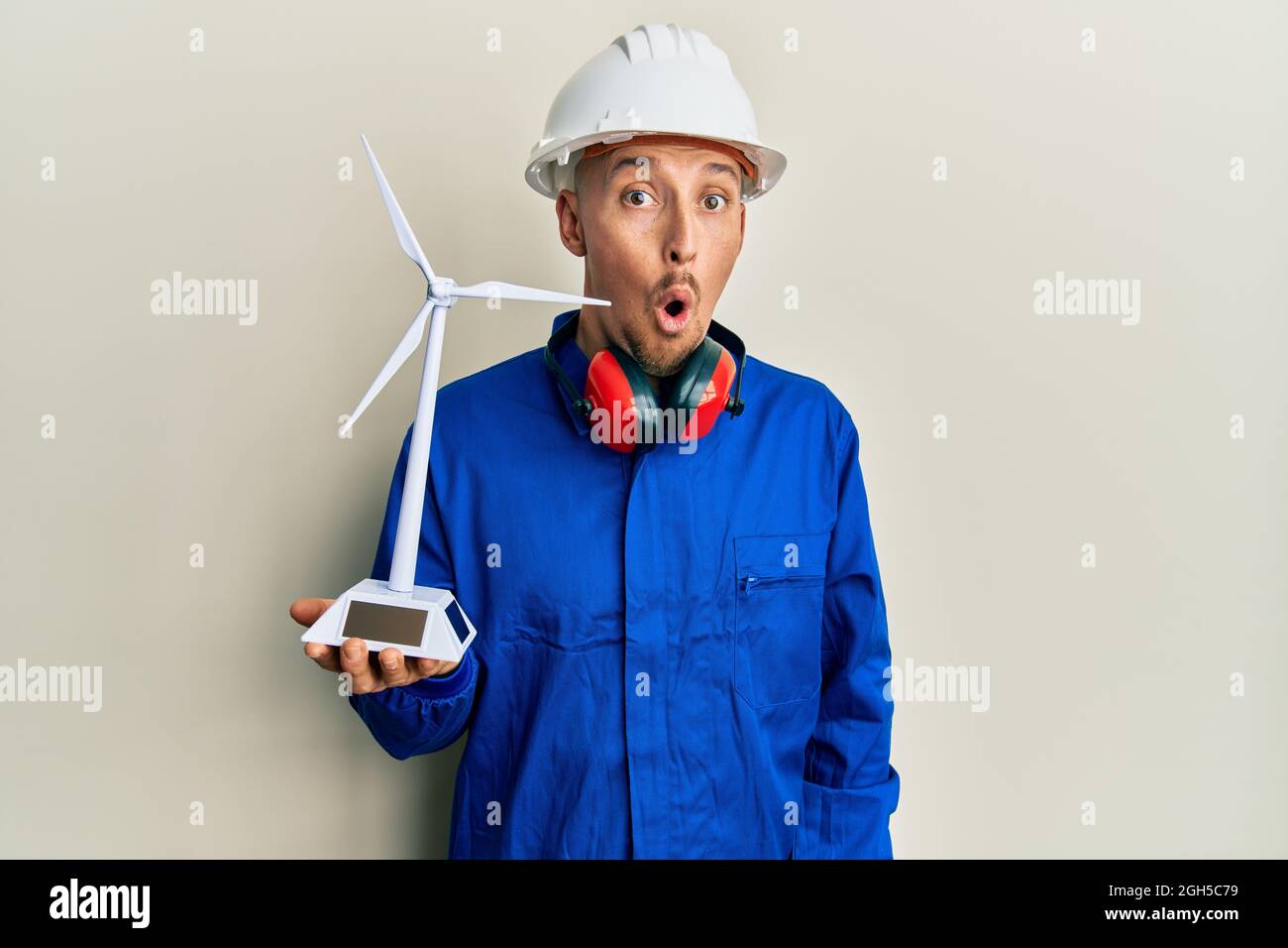 Bald Engineer Man With Beard Holding Solar Windmill For Renewable