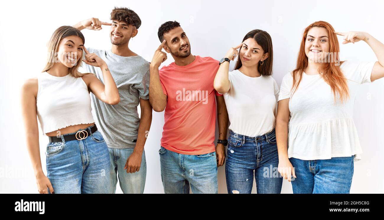 Group of young friends standing together over isolated background ...