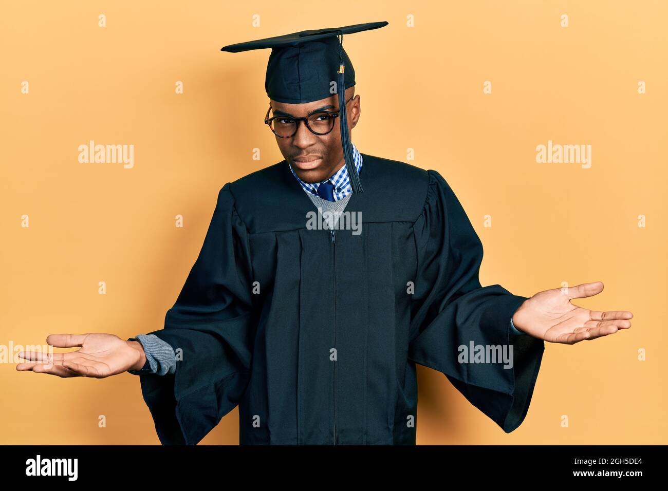 Young african american man wearing graduation cap and ceremony robe ...