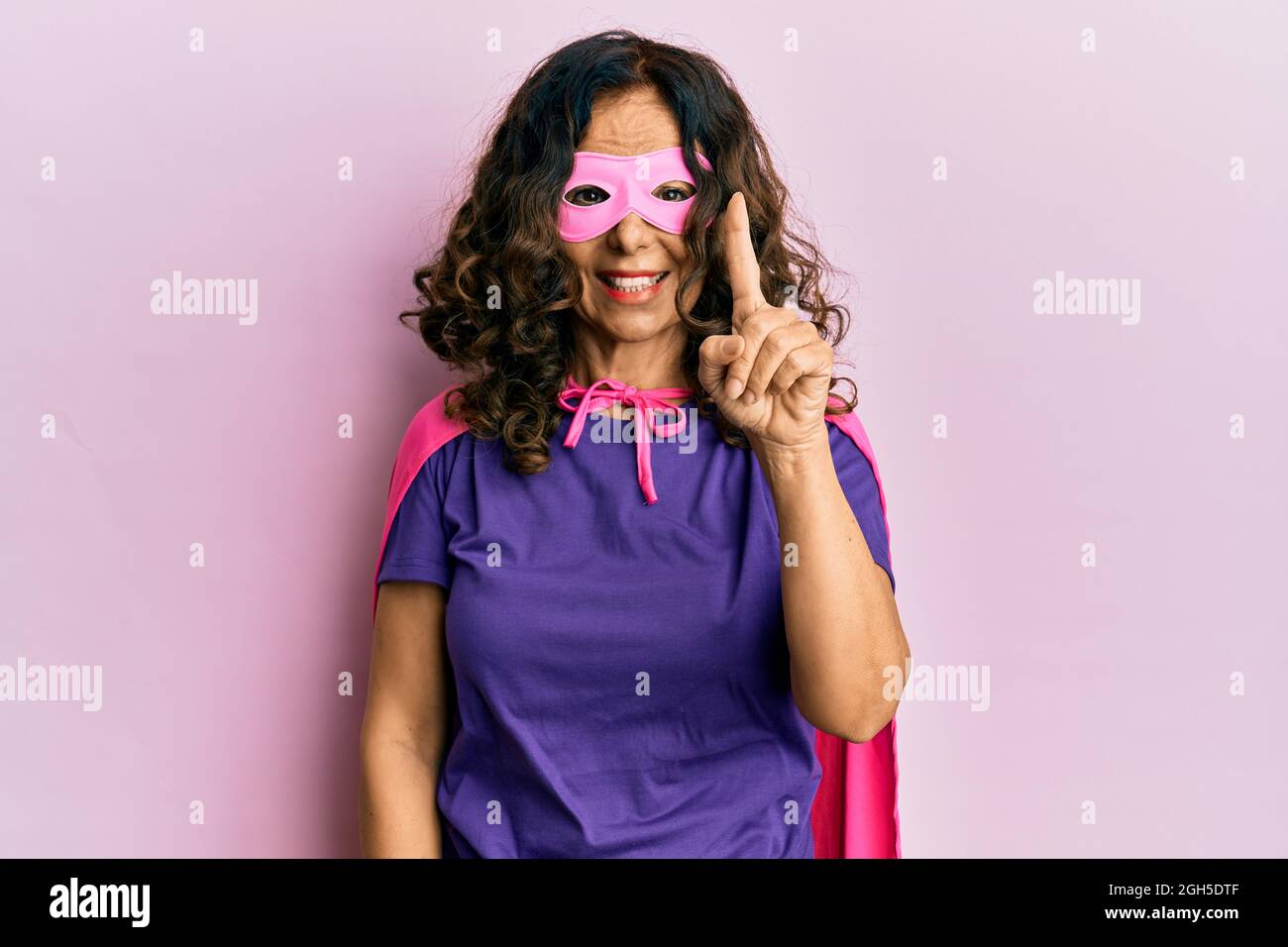 Middle age hispanic woman wearing super hero costume smiling with an ...