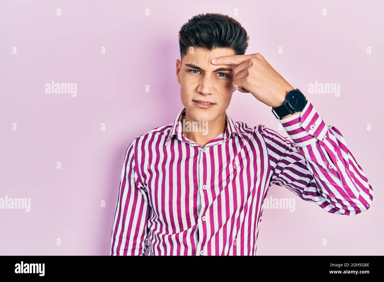 Young hispanic man wearing casual clothes pointing unhappy to pimple on ...