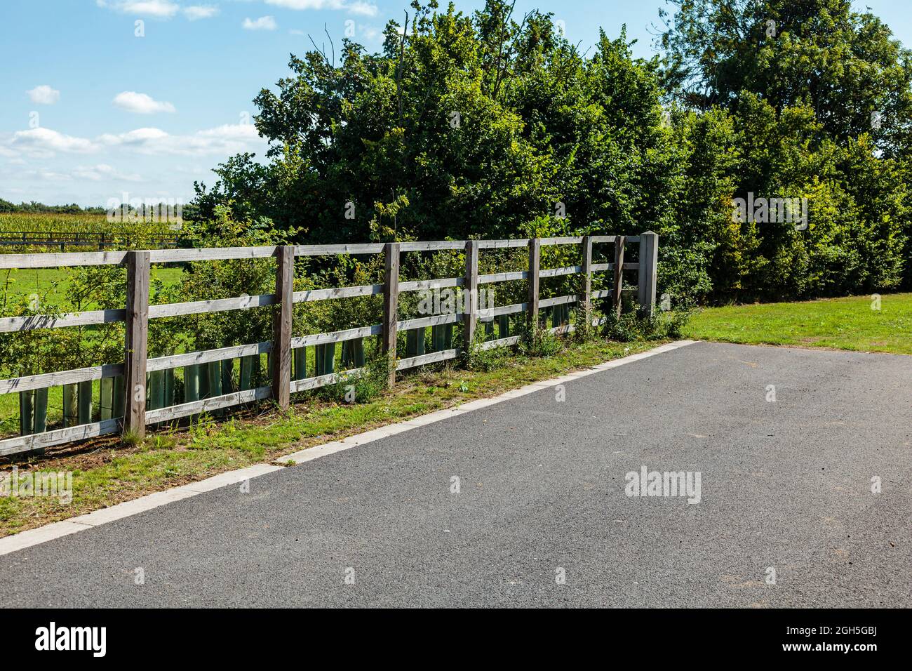 Car park with wooden fence on a sunny day Stock Photo - Alamy