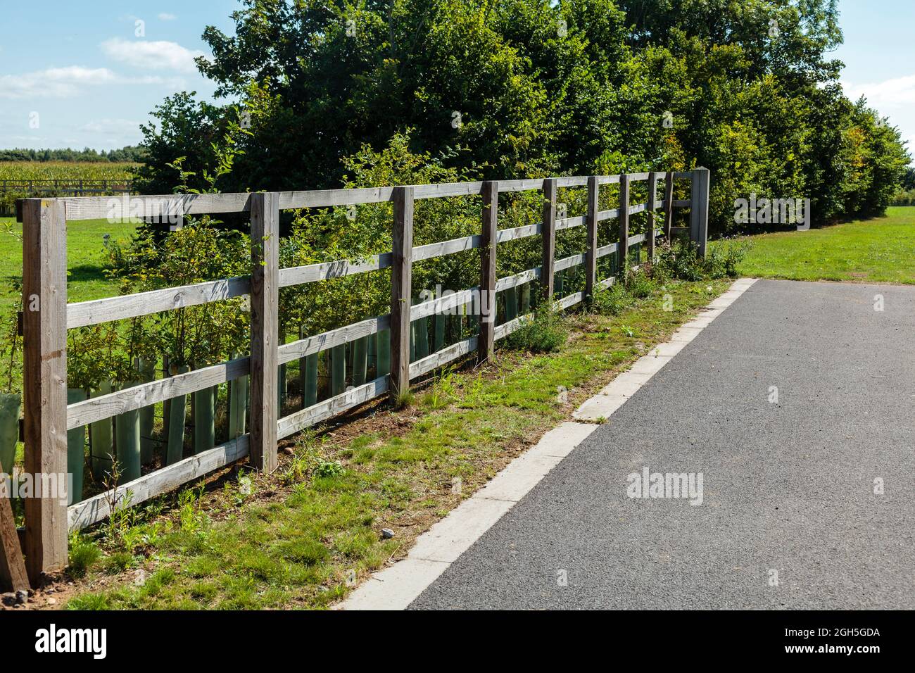 Car park with wooden fence on a sunny day Stock Photo - Alamy