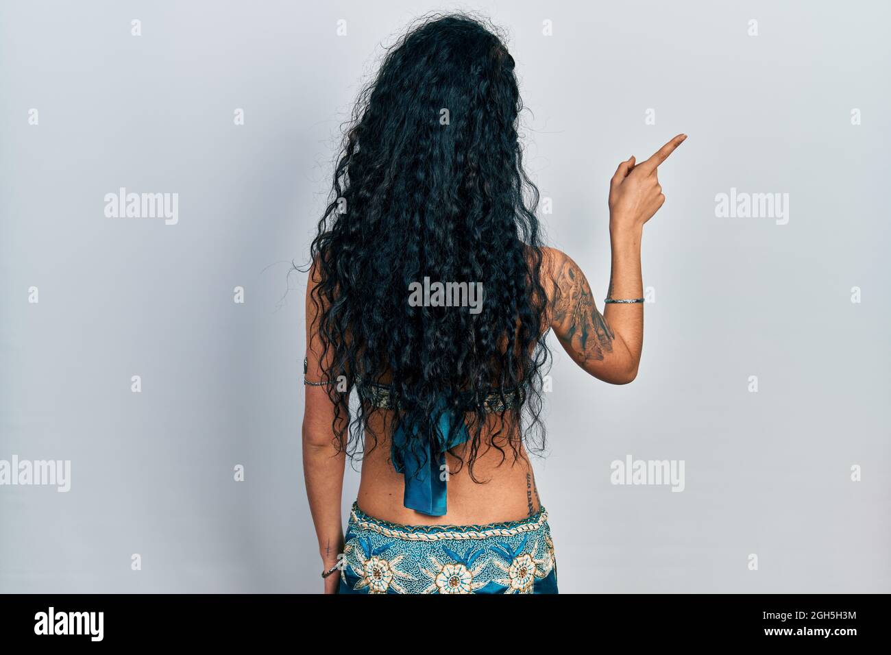 Young woman wearing bindi and traditional belly dance clothes posing ...