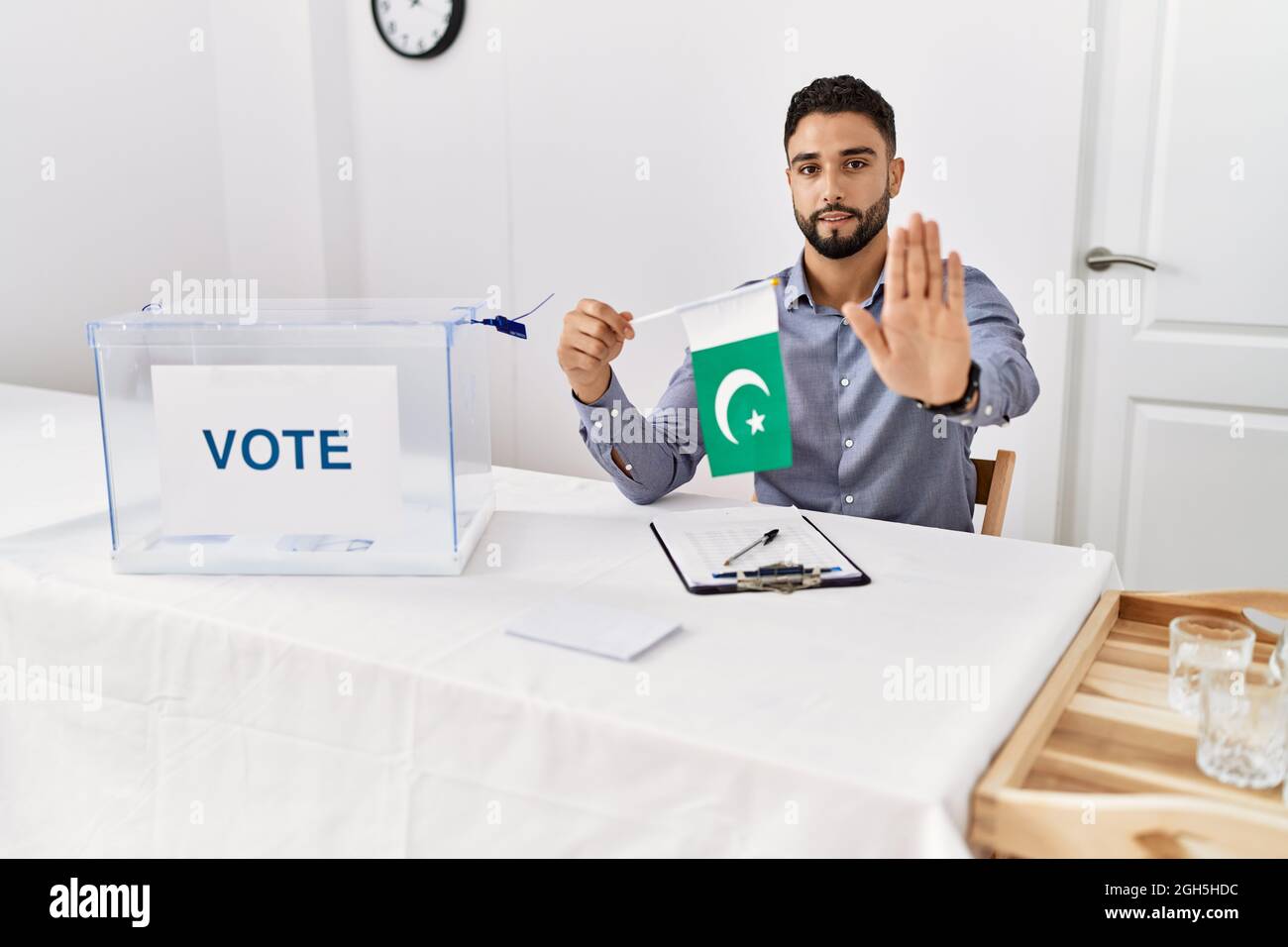 Young handsome man with beard at political campaign election holding ...