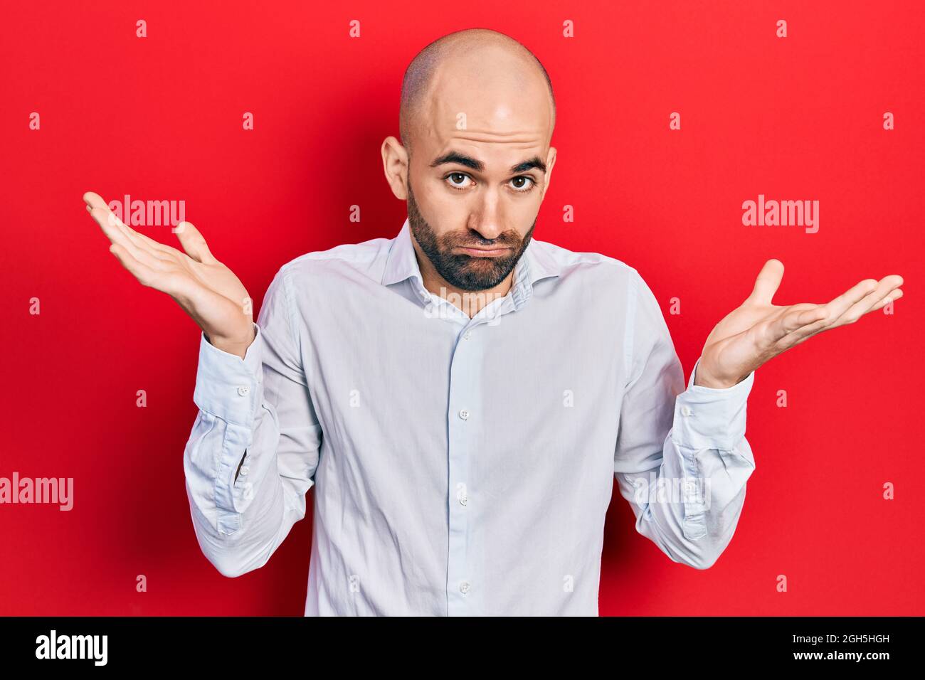 Young bald man wearing elegant clothes clueless and confused with open ...
