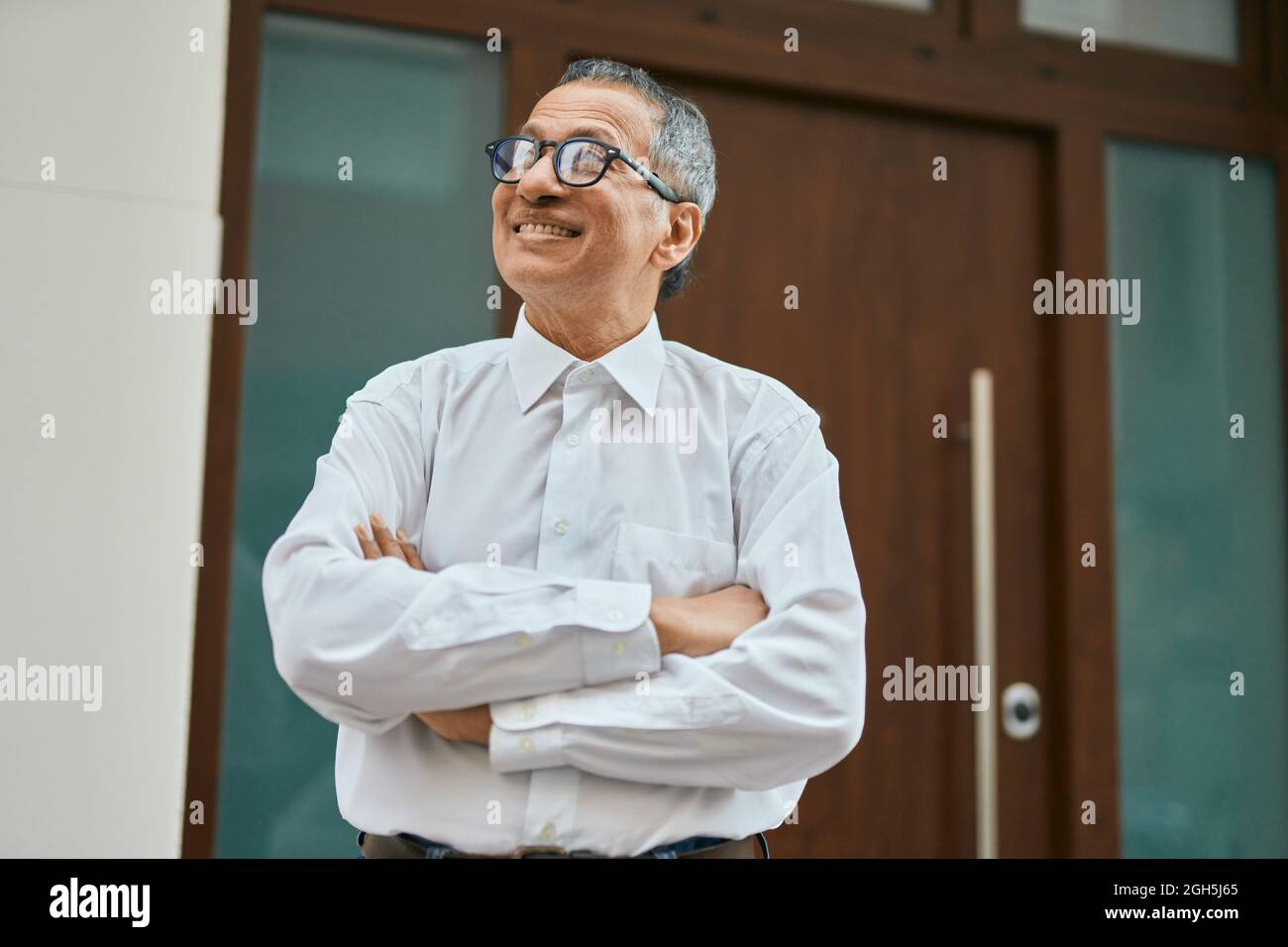 Middle age southeast asian man smiling confident with crossed arms by ...