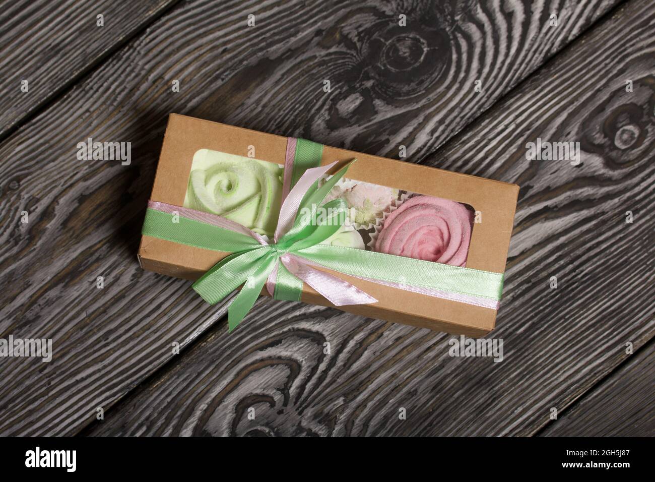 Zephyr in craft packaging. Marshmallow in the form of roses. In pink ...