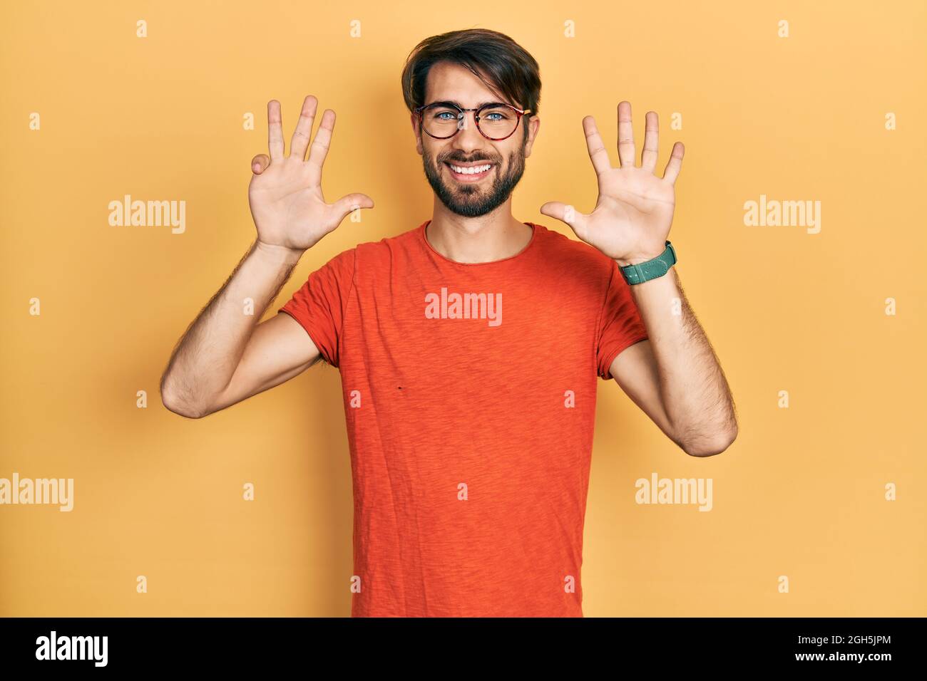 Young hispanic man wearing casual clothes and glasses showing and ...