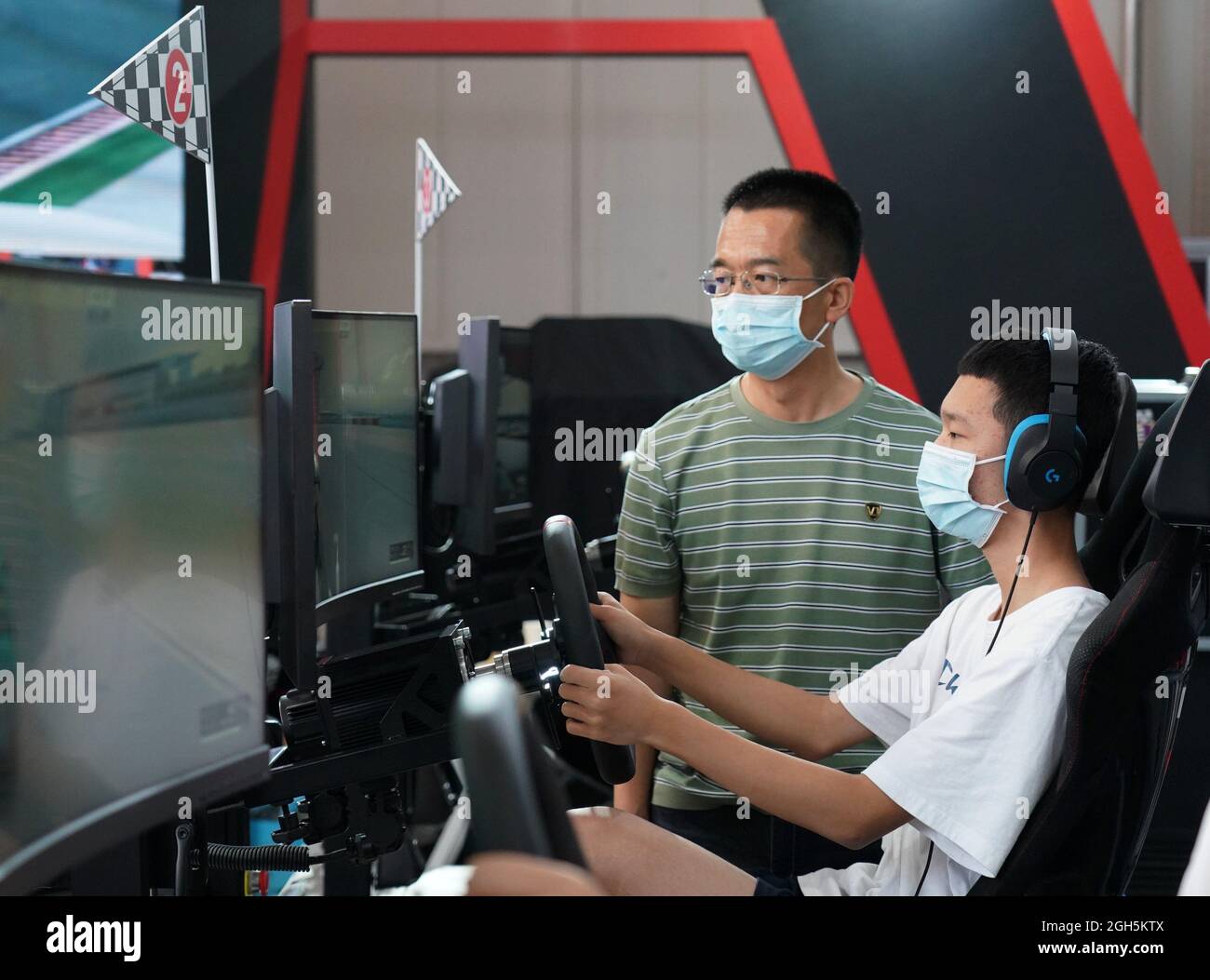 Beijing, China. 5th Sep, 2021. A visitor experiences a car racing ...