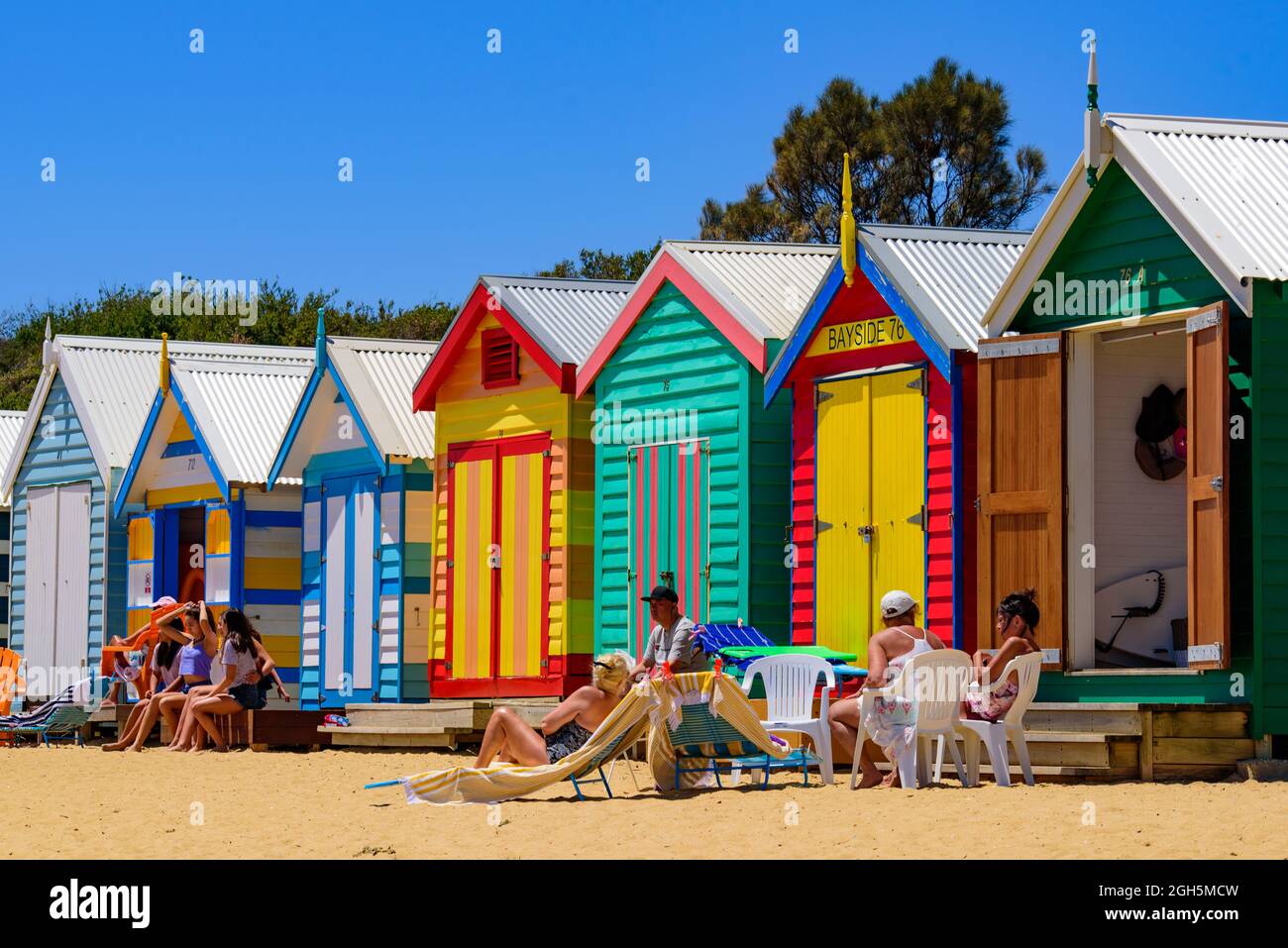 People having fun on the Brighton Beach with colorful Bathing Boxes as ...