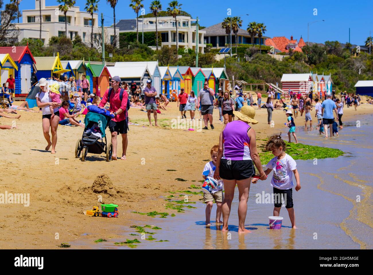People having fun on the Brighton Beach with colorful Bathing Boxes as ...
