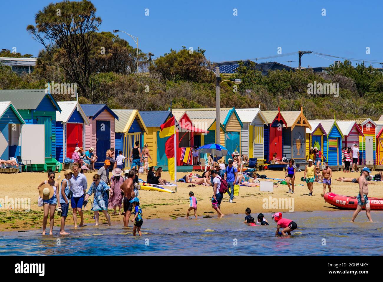 People having fun on the Brighton Beach with colorful Bathing Boxes as ...