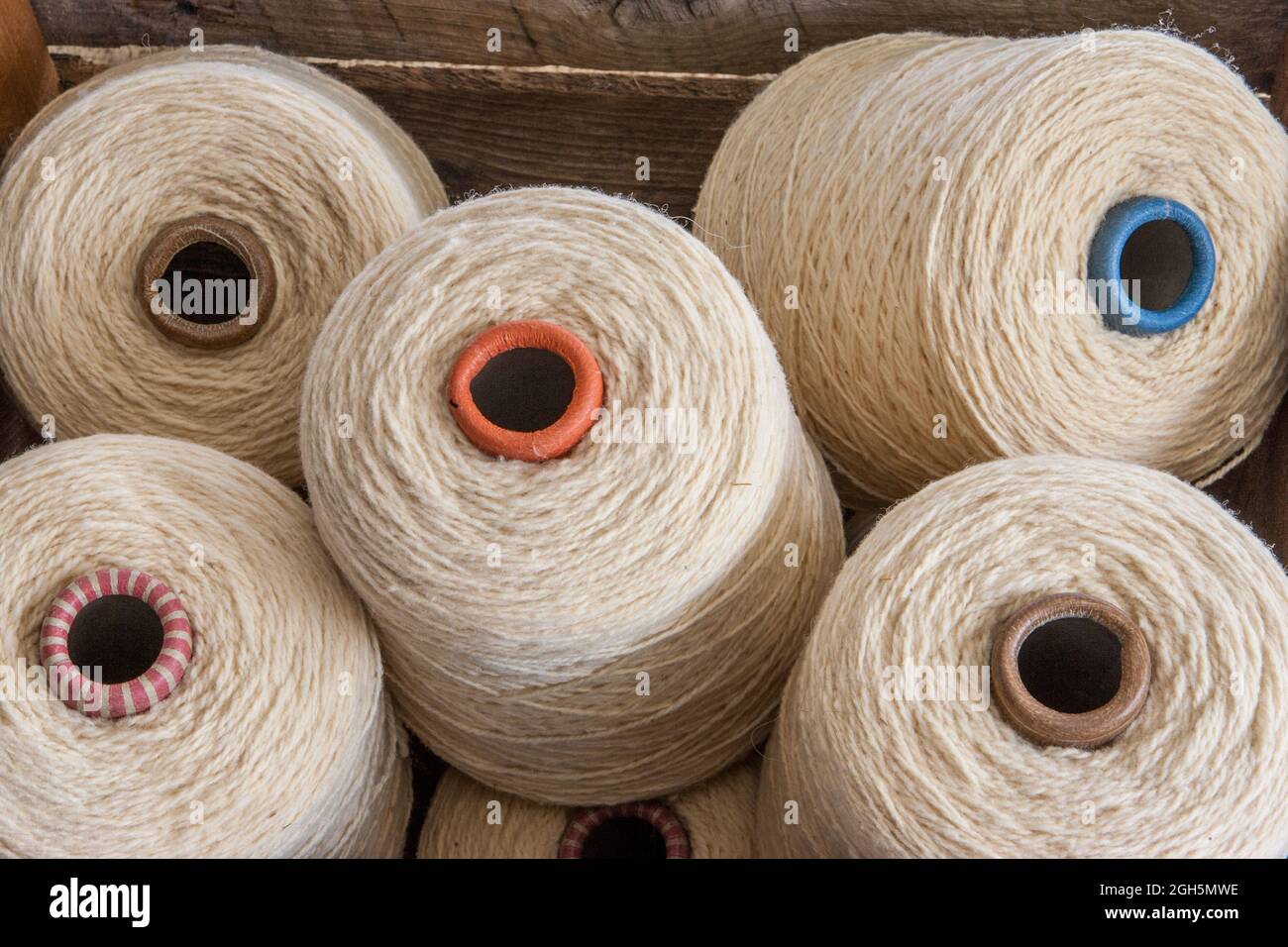Spools of wool yarn ready for weaving Stock Photo - Alamy