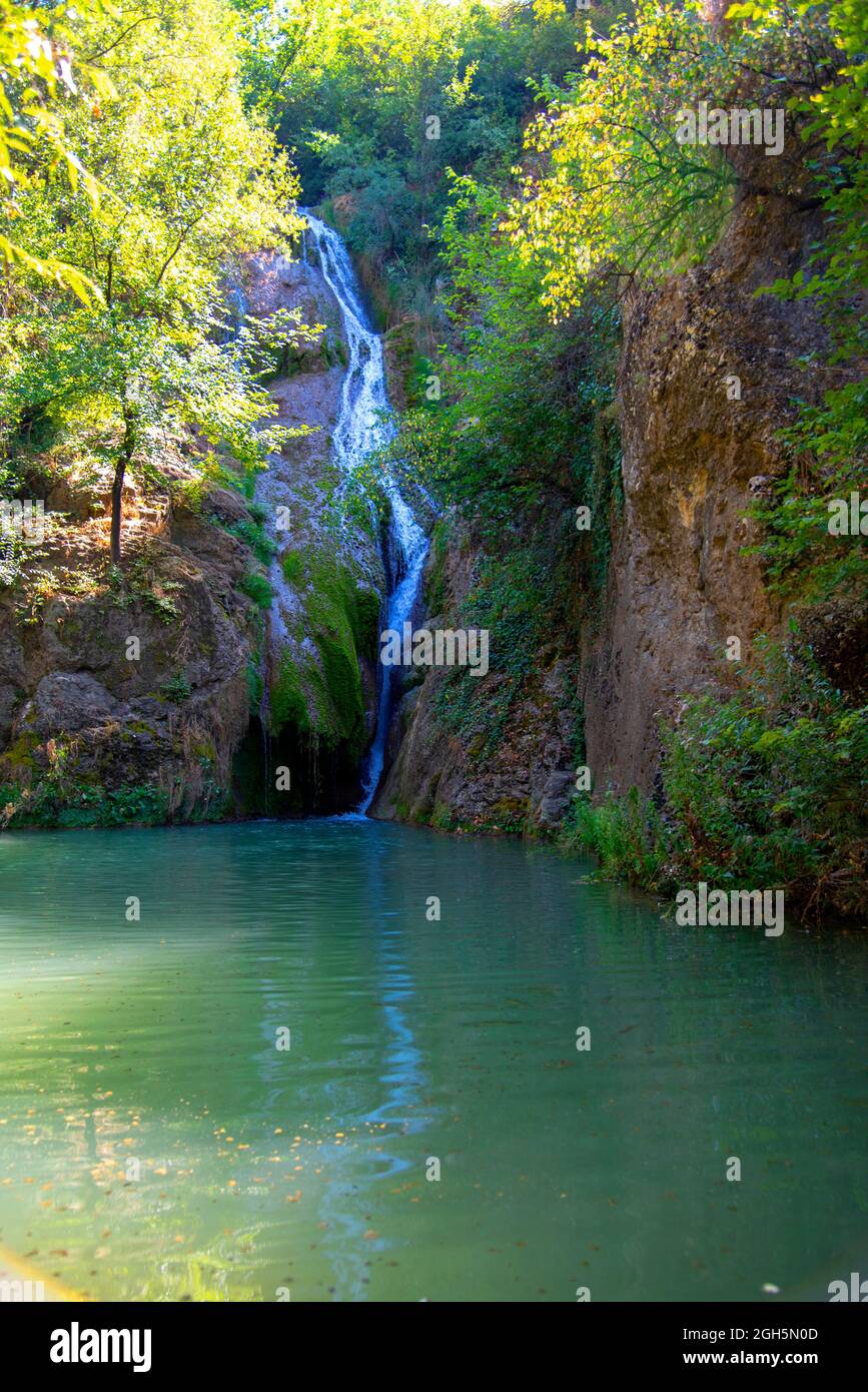 Mountain waterfall. Powerful jets of water flow into the lake ...
