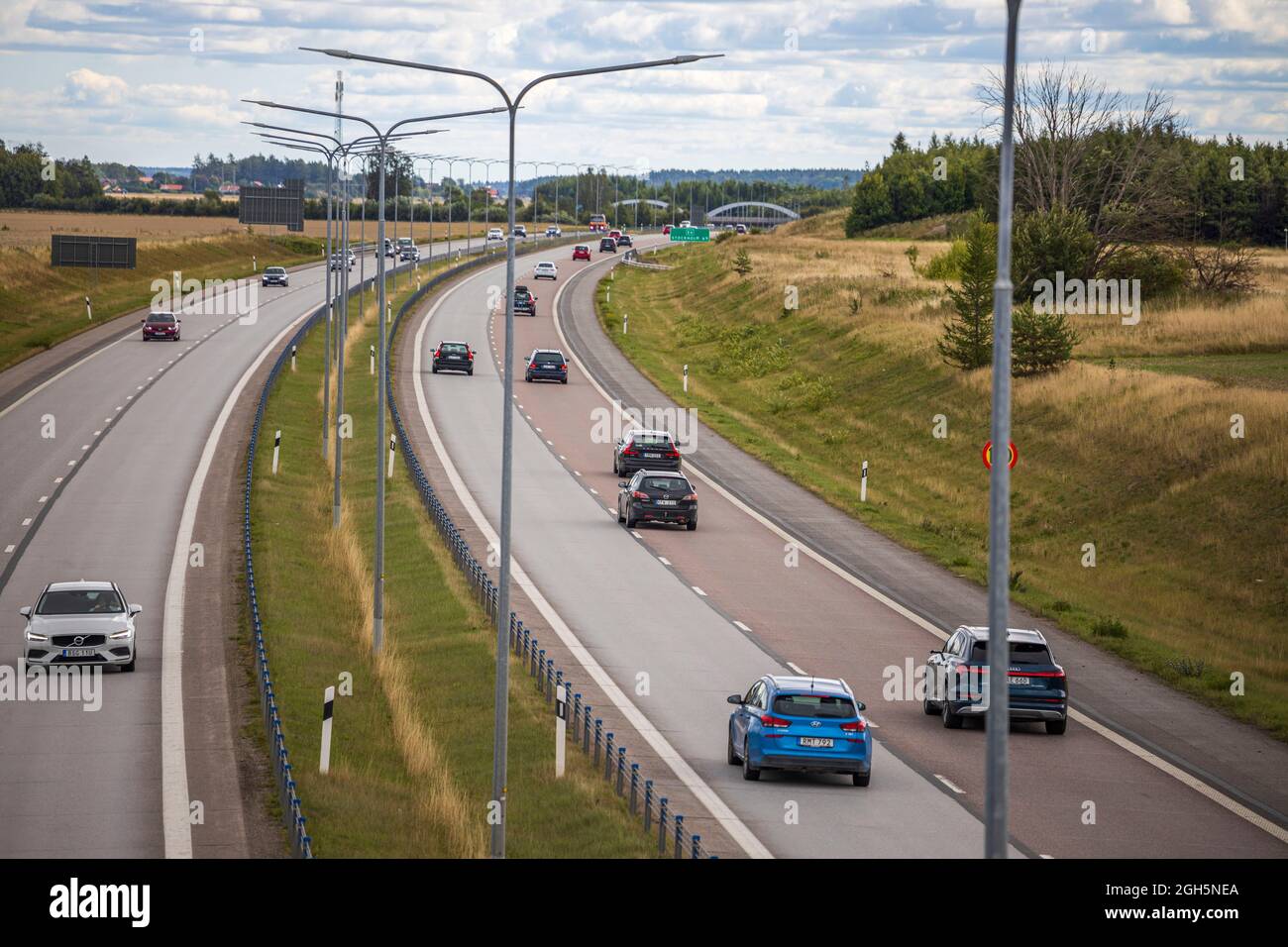 Beautiful view from above on highway road with several cars. Green side ...