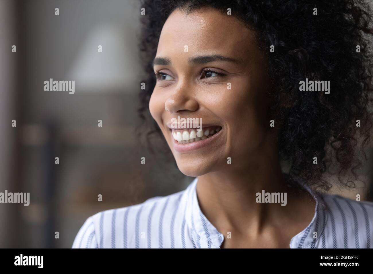 Attractive young black lady look at distance with beautiful smile Stock ...
