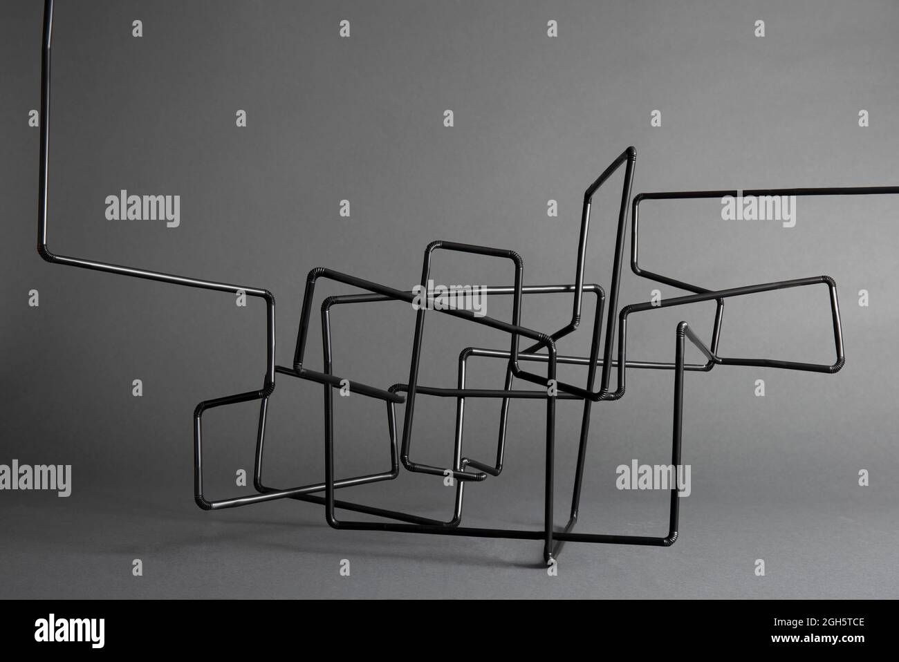 Black and white abstract tangled sculpture made of metal tubes with ...