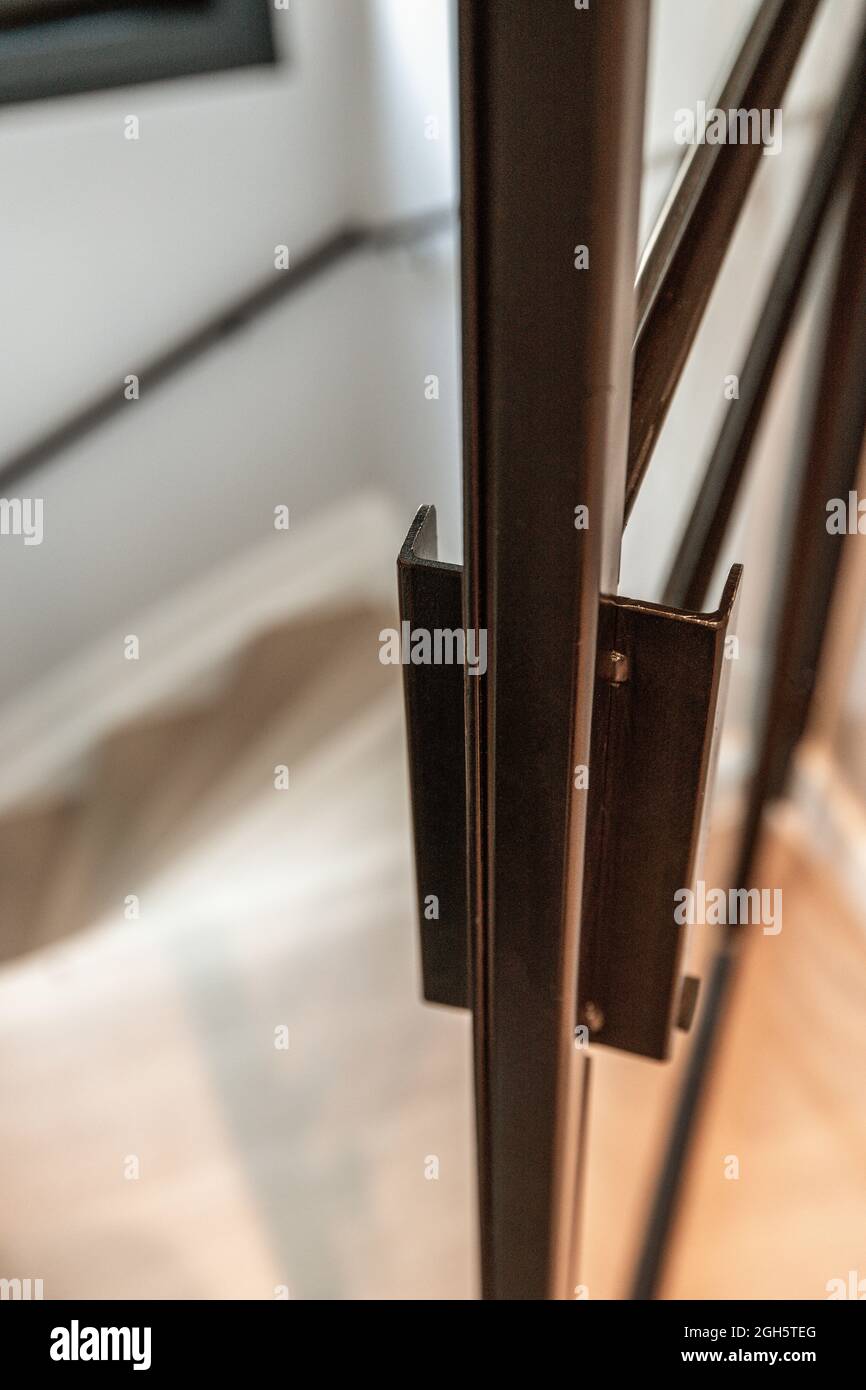 From above of metal door handle of modern glass door leading to ...