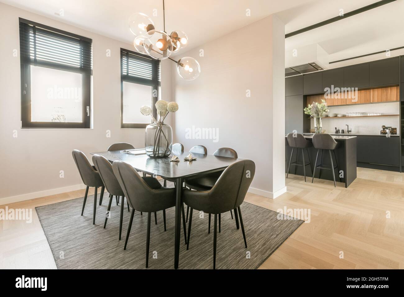 Interior of dining room with black table and chairs in contemporary ...
