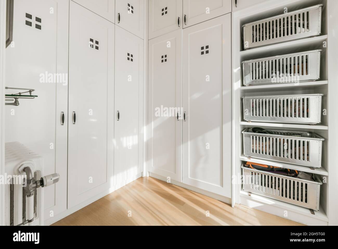 Interior of spacious store room with white built in cupboard and ...