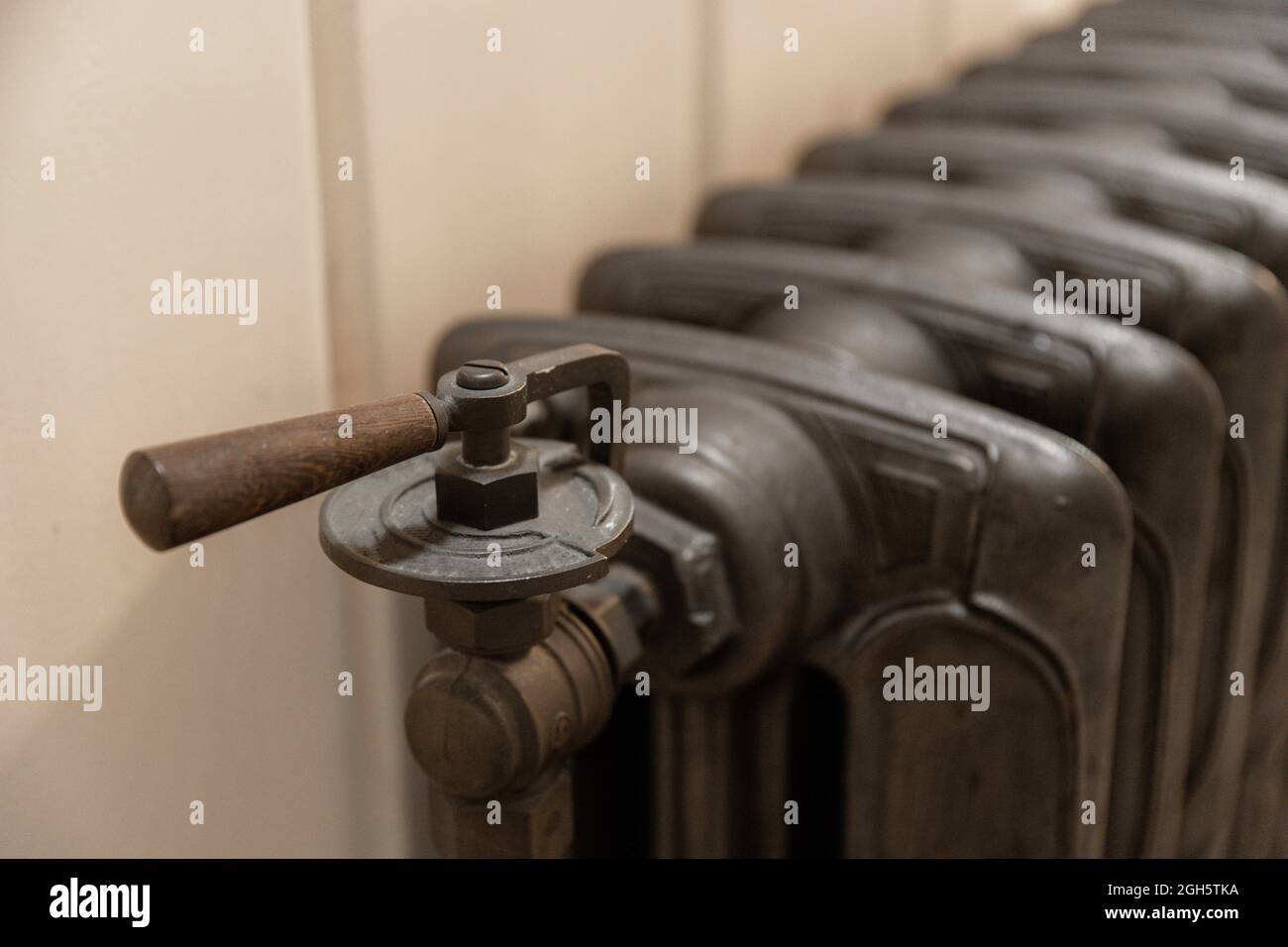 Rusty metal valve of old radiator for temperature regulation in room at ...