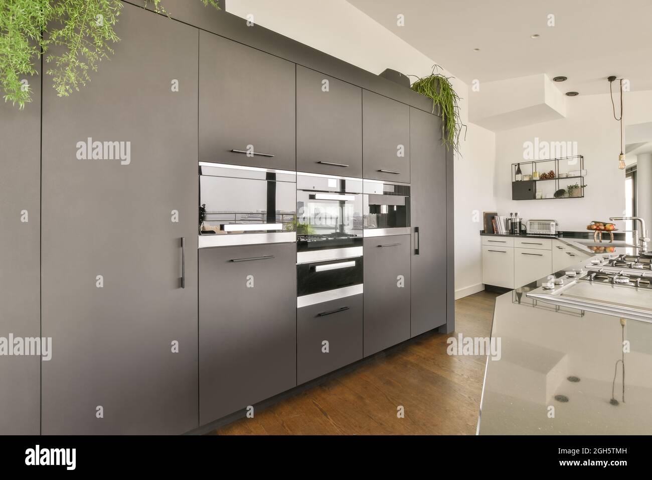 Open plan kitchen in modern loft style apartment with white walls and ...
