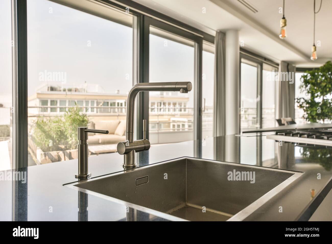 Detail of interior design of modern kitchen with chrome faucet and sink ...