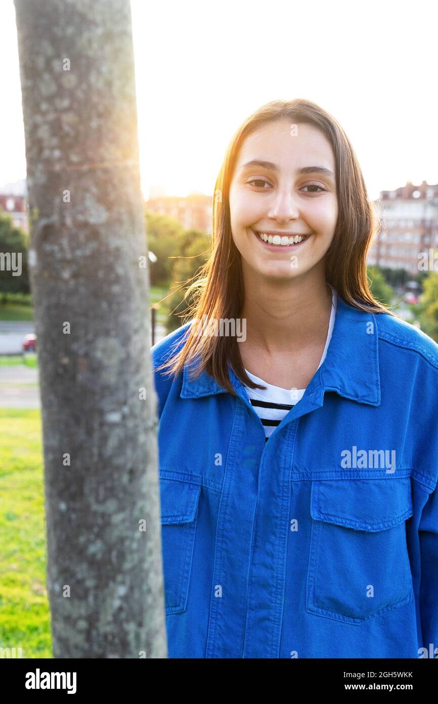 Woman peeking tree hi-res stock photography and images - Alamy