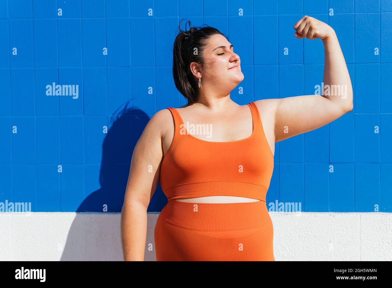 Powerful plus size ethnic female athlete in sportswear demonstrating ...