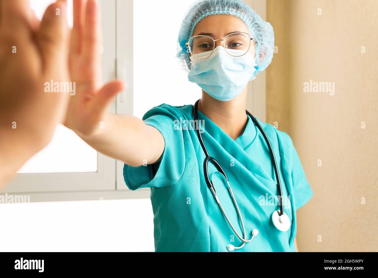 Crop unrecognizable male medic giving high five to female colleague ...
