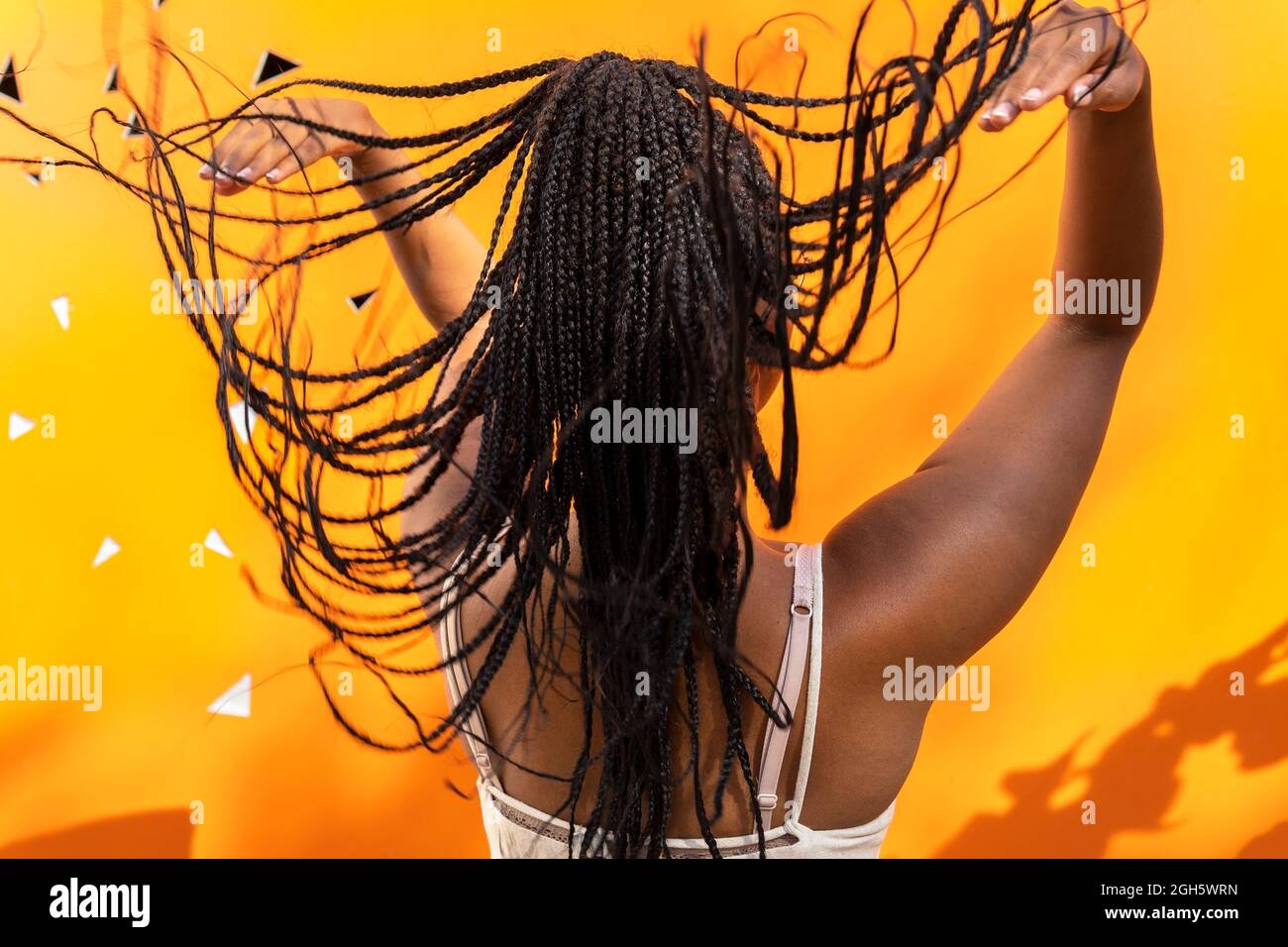 Back view of unrecognizable African American female throwing long ...