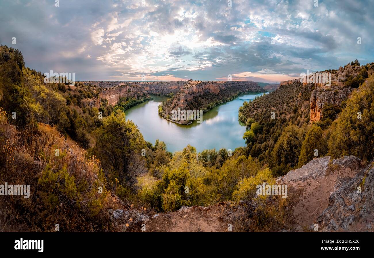 Scenic view of mounts with autumn trees and river under shiny sky with ...