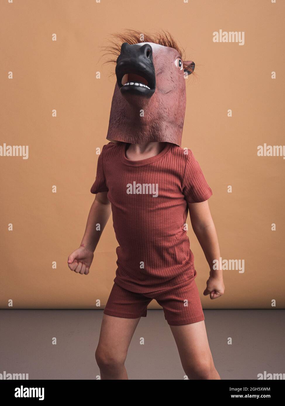 Anonymous kid in horse mask representing galloping stallion concept on ...