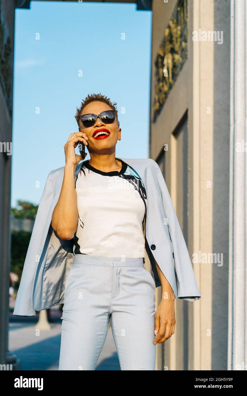 Crop calm male with blue hair applying drag makeup and reflecting in ...