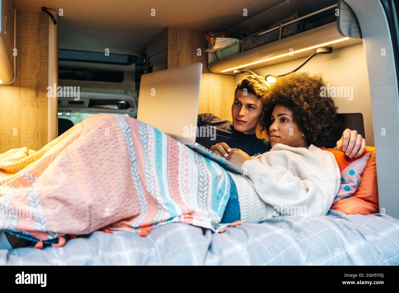 Happy romantic multiracial couple cuddling and enjoying time together ...