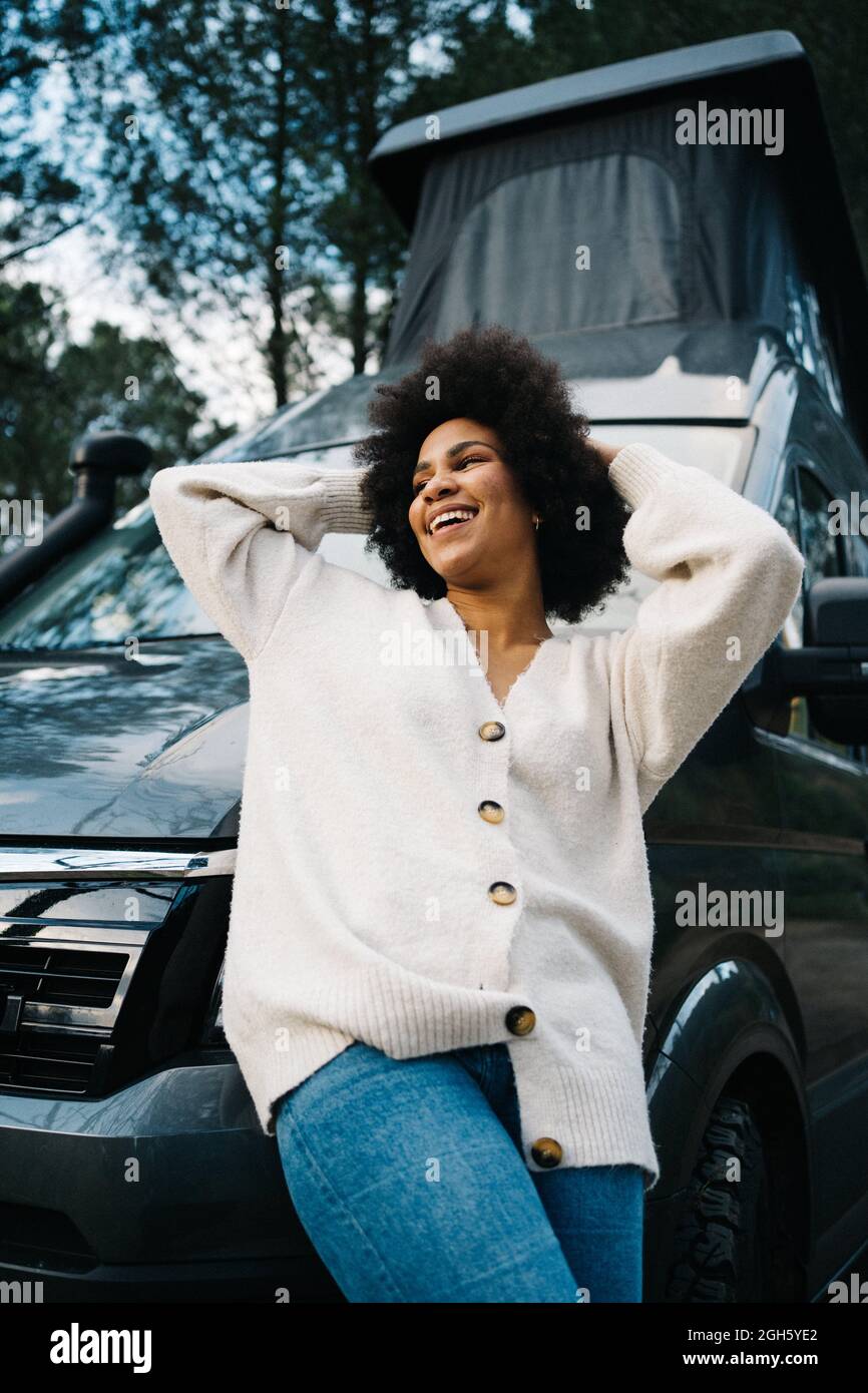 Cheerful young African American female traveler in casual clothes ...
