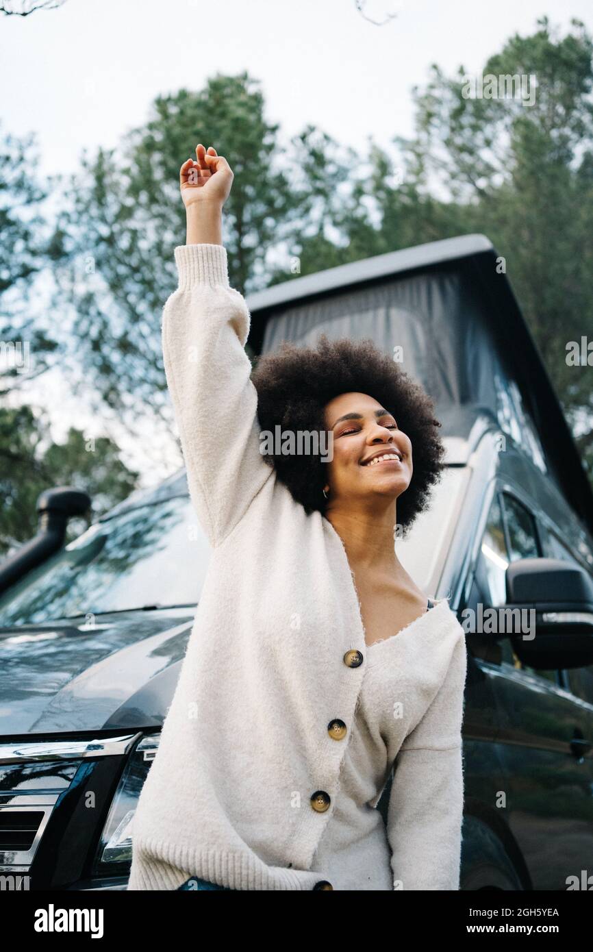 Cheerful young African American female traveler in casual clothes ...