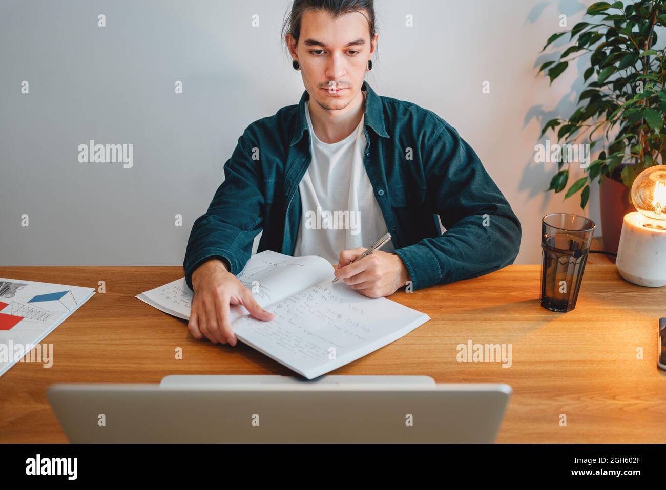 Сollege student studying while online learning using laptop at campus ...
