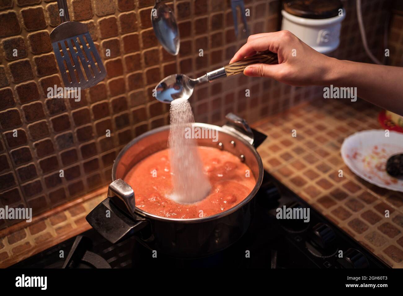 Woman adding salt to food hi-res stock photography and images - Alamy
