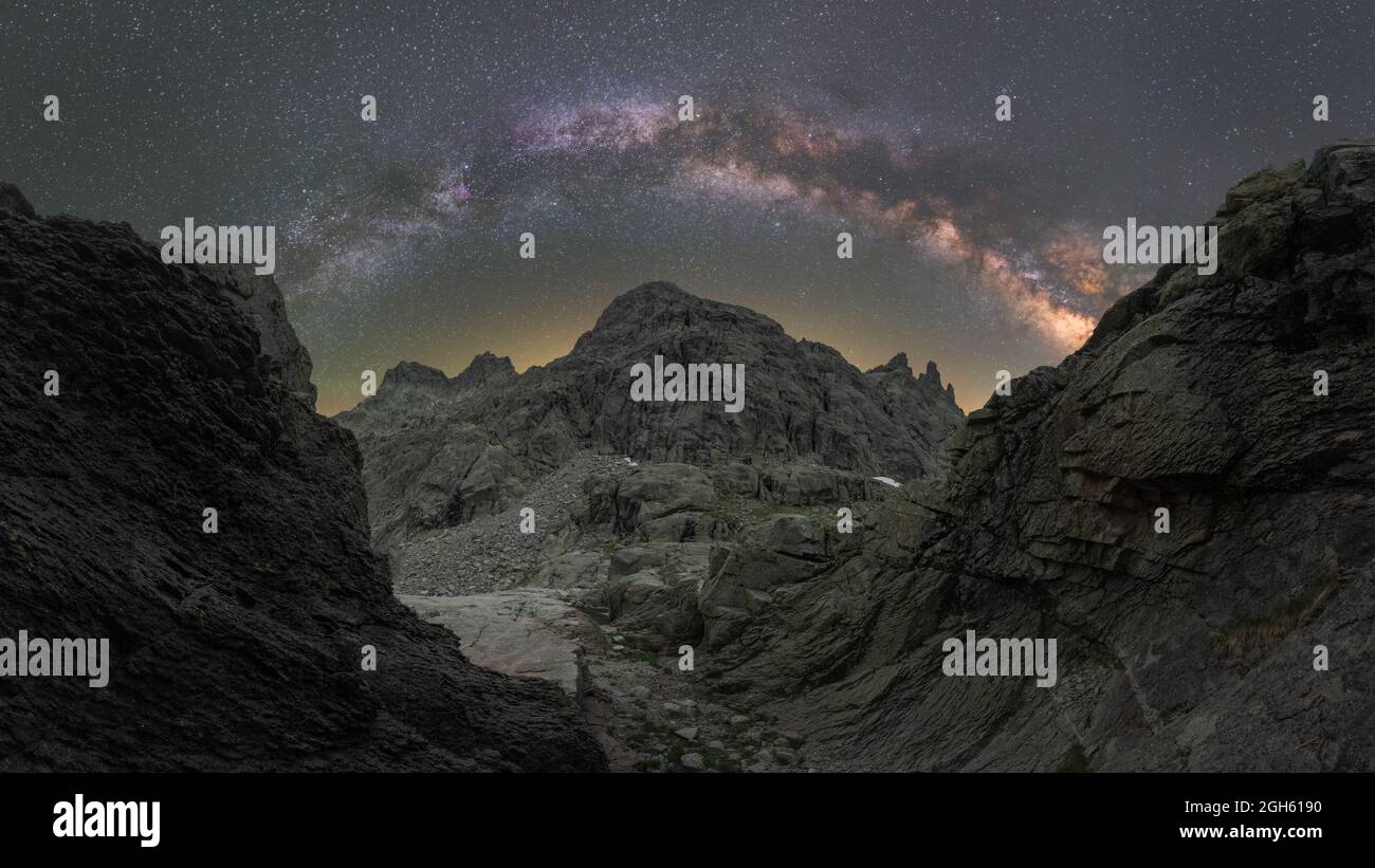 Spectacular view of galaxy in sky with interstellar gas over rough ...