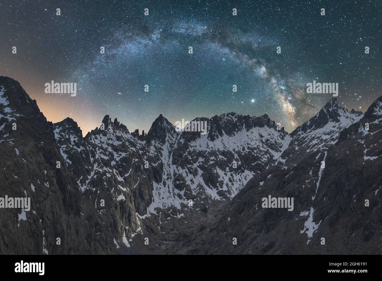 Spectacular view of galaxy in sky with interstellar gas over rough ...