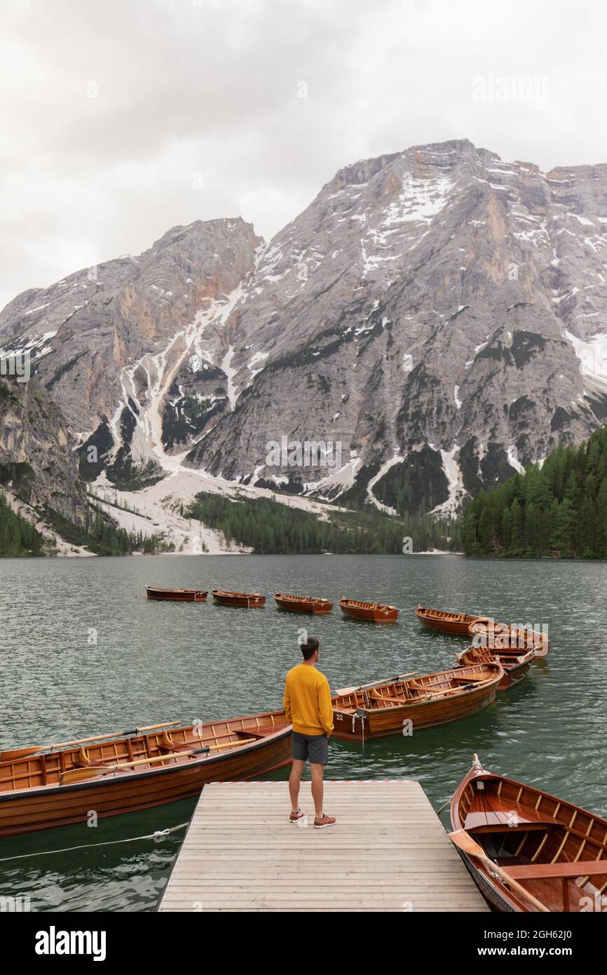 Back view of unrecognizable male explorer in yellow sweatshirt standing ...