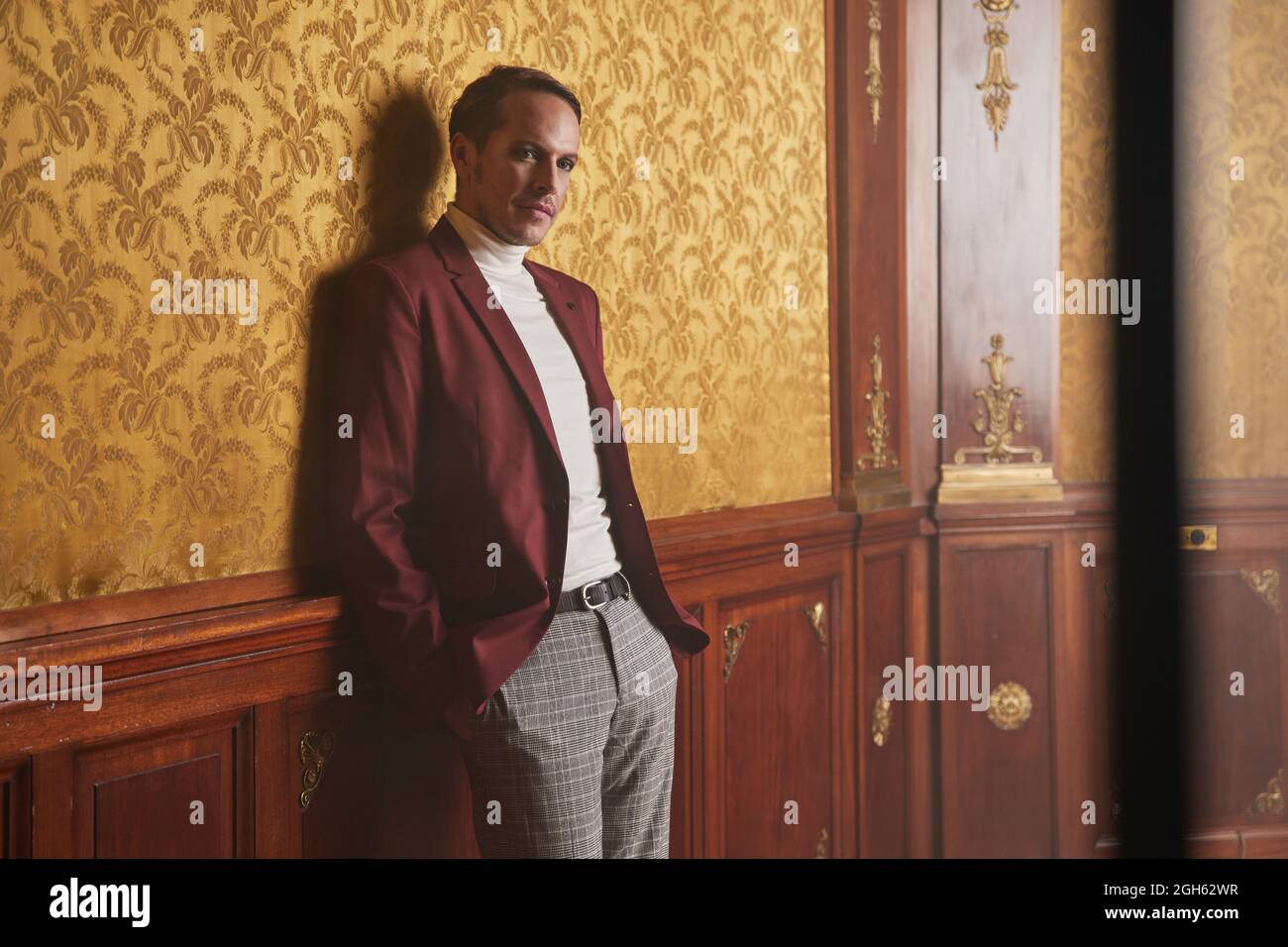 Confident adult male actor in elegant classy clothes keeping hand in ...
