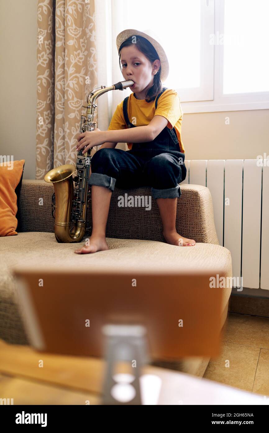 Charming girl sitting on couch hi-res stock photography and images - Alamy